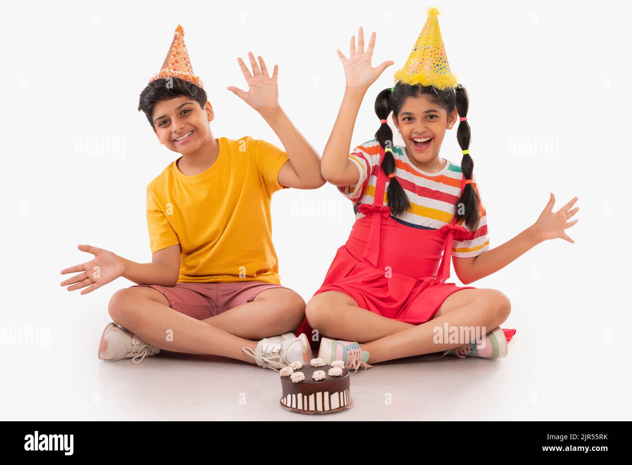 Happy boy and girl celebrating birthday together Stock Photo - Alamy