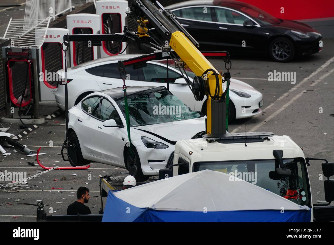 A damaged Tesla car is removed from the scene of a fatal crash in Park ...