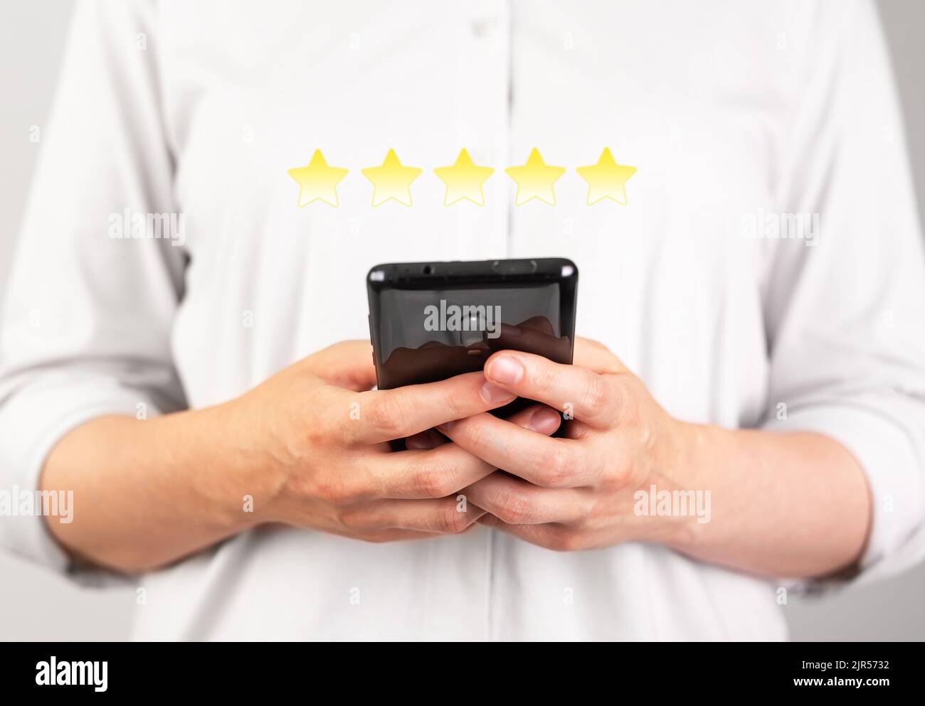 Hands holding phone for giving good feedback. Woman submitting five ...