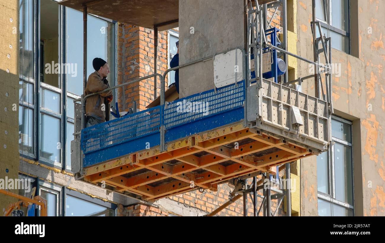 Kyiv,Ukraine - 24.04.2019: Construction workers move down on the ...