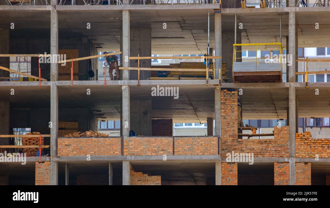 Skyscrapper building construction workers in different rooms. Workers ...