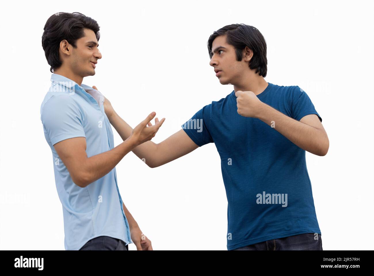 One teenage boy pulling the other by the collar of his shirt against ...