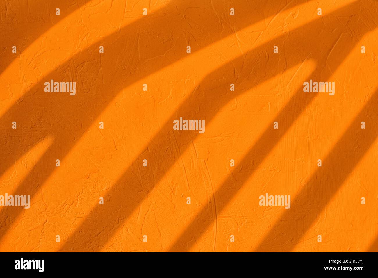 Shadow and light on solid orange wall texture background Stock Photo ...