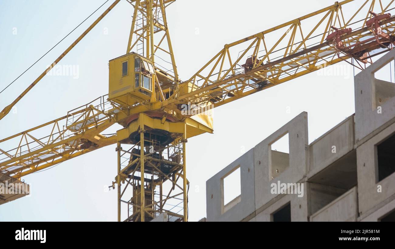 Yellow crane on the background of building. White sky background Stock ...