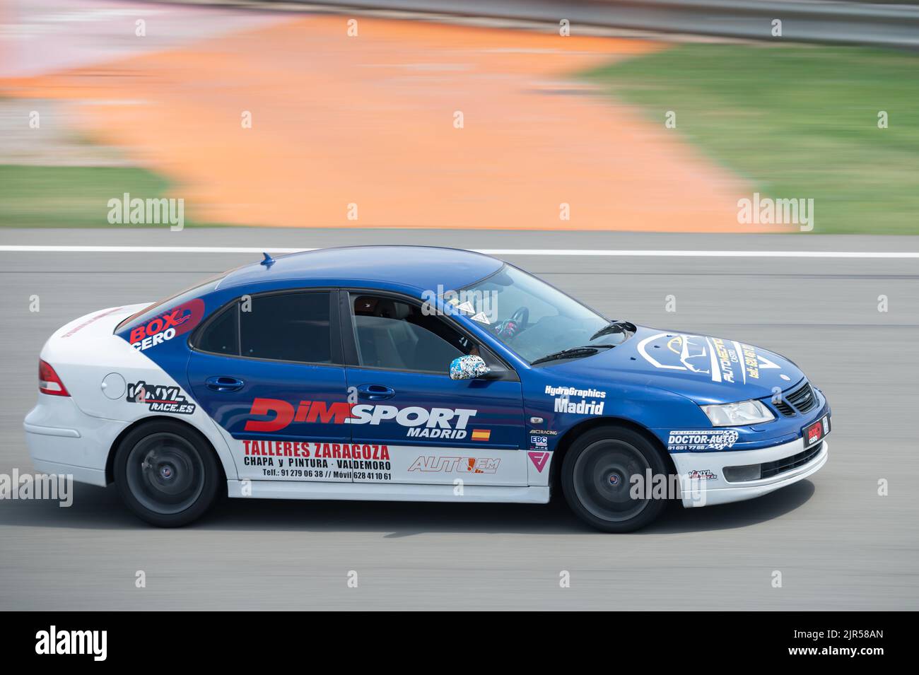 A panning of a Saab 9-3 racing around the race track Stock Photo - Alamy