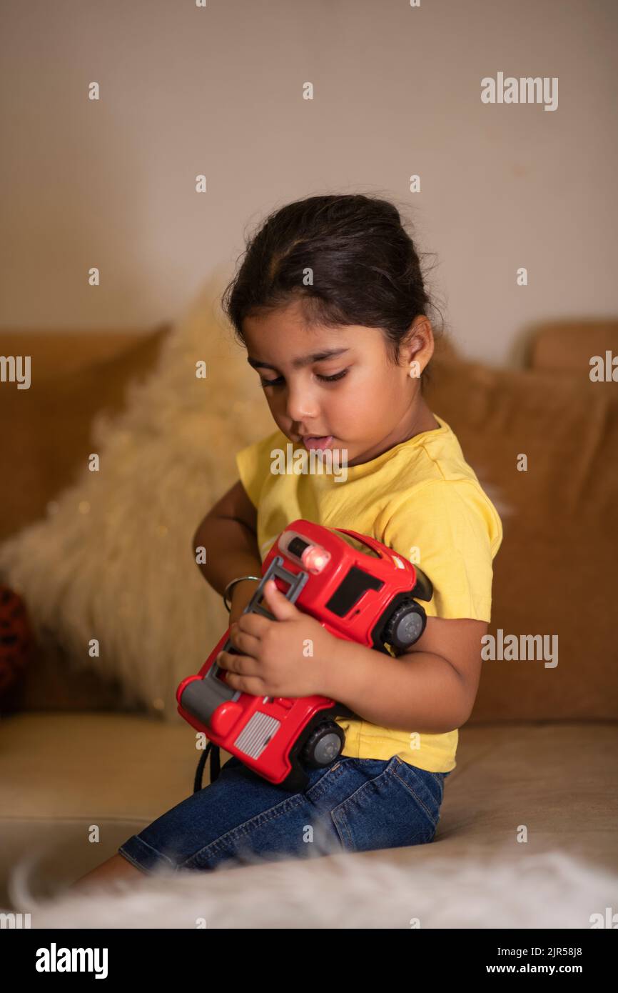 Little girl playing with toy car at home Stock Photo - Alamy
