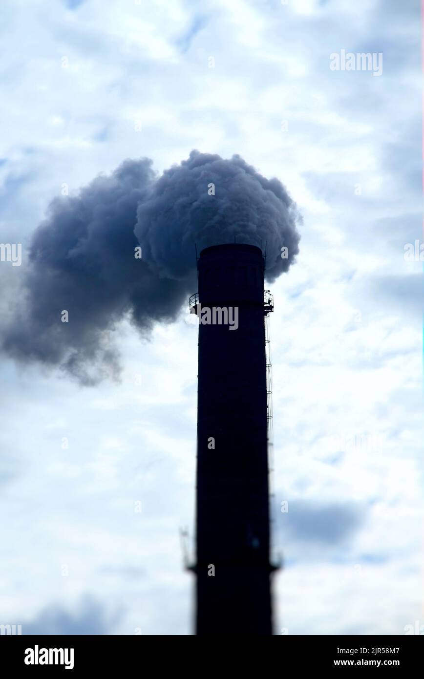 Smoke stack in working plant emitting smog and air pollution Stock ...