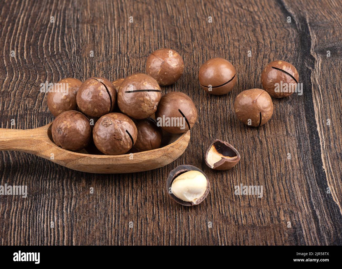 Macadamia nuts and nut shells on a wooden background. Copy space Stock ...