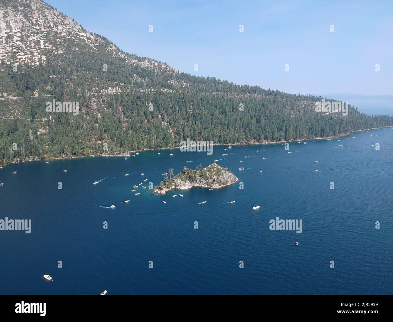 A drone view of the beautiful Emerald Bay full of white boats in ...