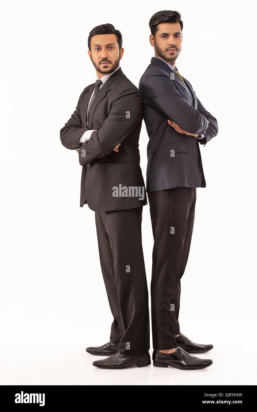 Two corporate employees in formal business suit Standing back to back ...