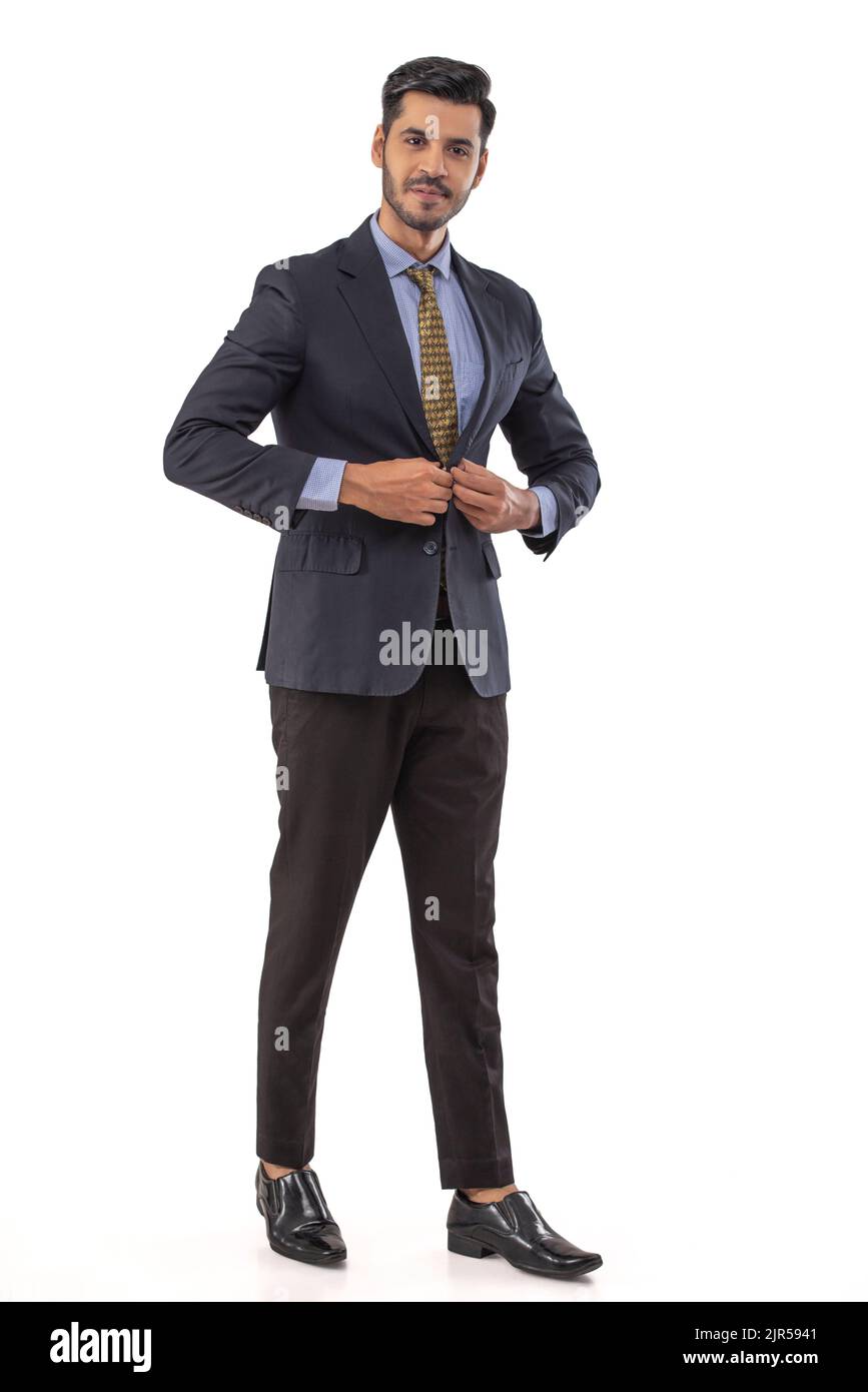 Portrait of a corporate employee in formal business suit standing while ...