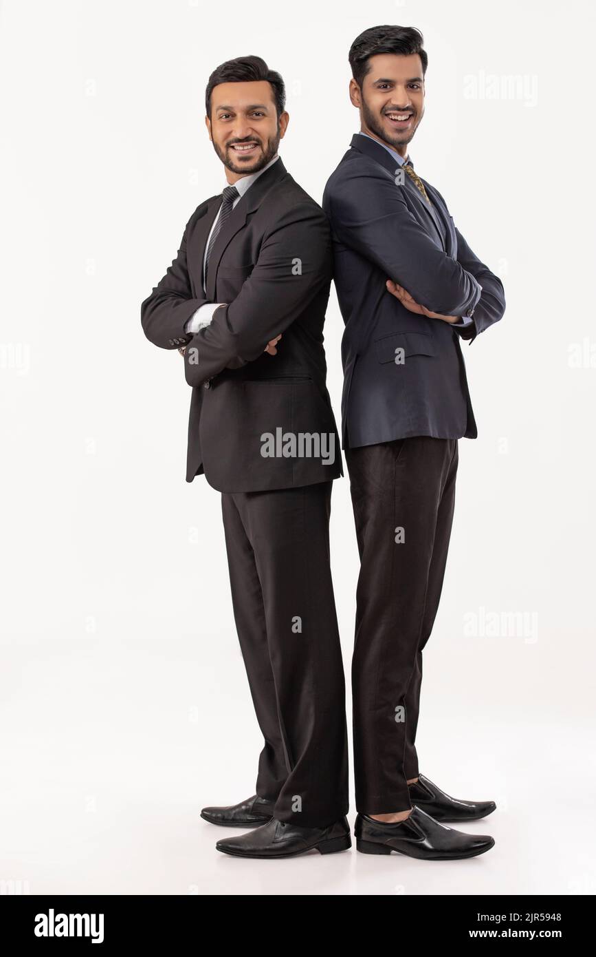 Two corporate employees in formal business suit Standing back to back ...