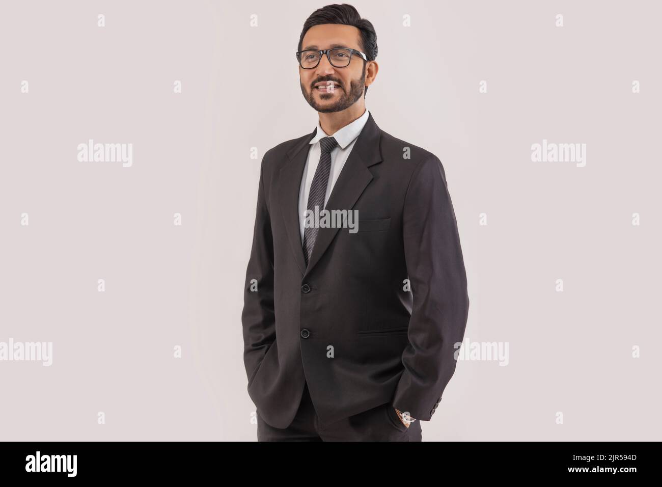 Portrait of a corporate employee in formal business suit standing with ...