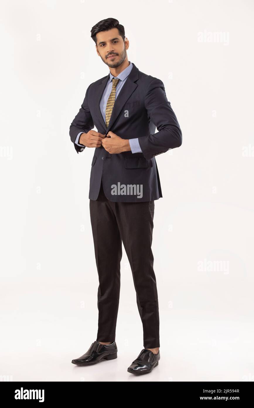 Portrait of a corporate employee in formal business suit standing while ...