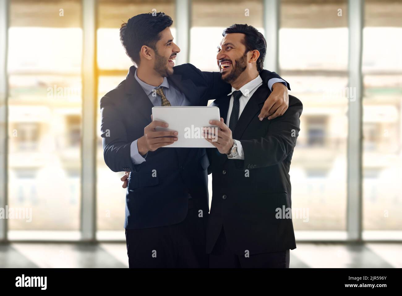 Corporate employees in formal business suit holding a digital tablet ...