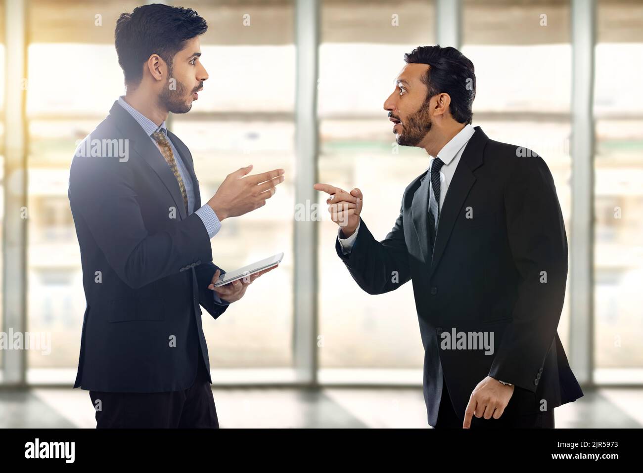 Corporate employees in formal business suit talking with one of them ...