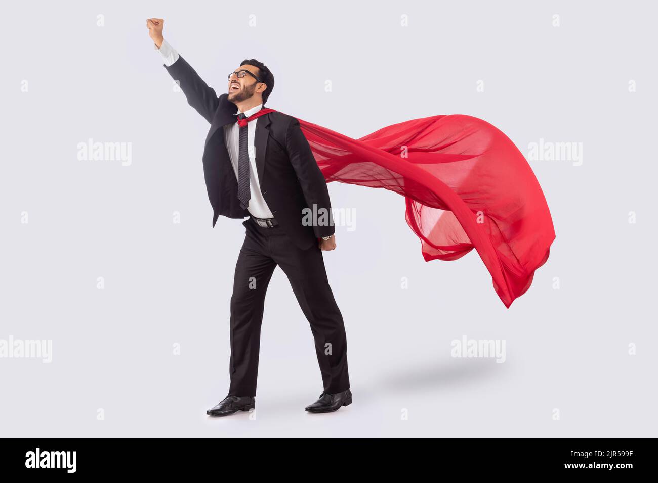 Corporate employee in formal business suit,wearing a cape to imitate ...