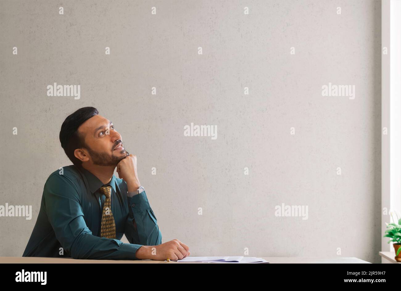 A corporate employee in formal clothing sitting and daydreaming Stock ...