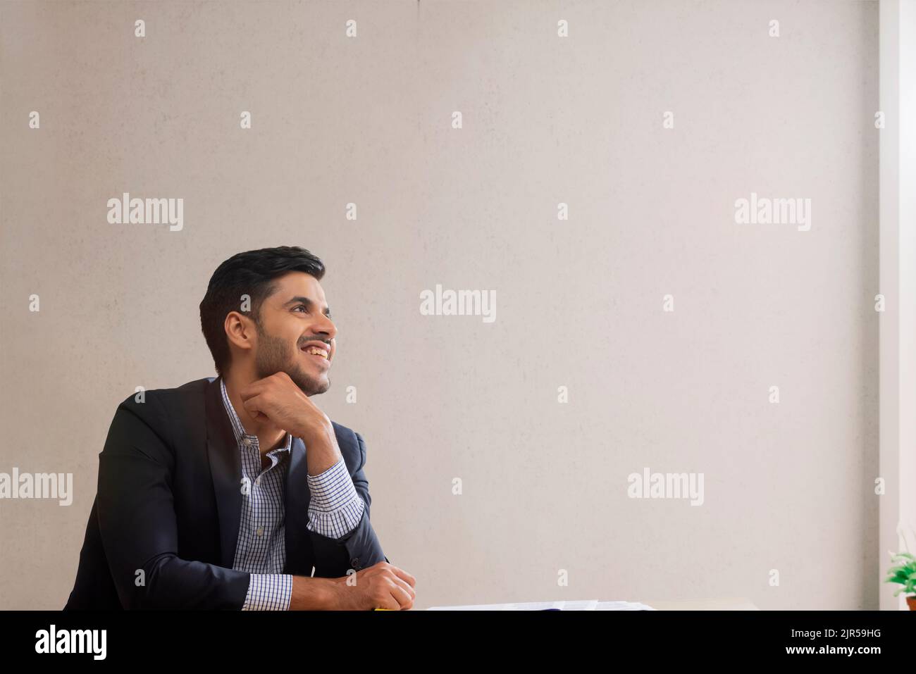 Portrait of a corporate employee in formal business suit sitting and ...