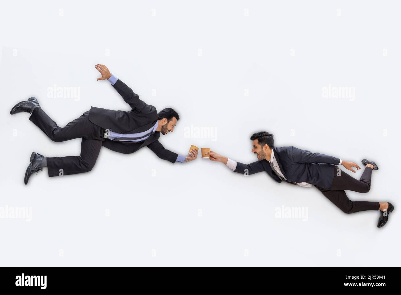 Corporate employees in formal business suit toasting with coffee cups ...