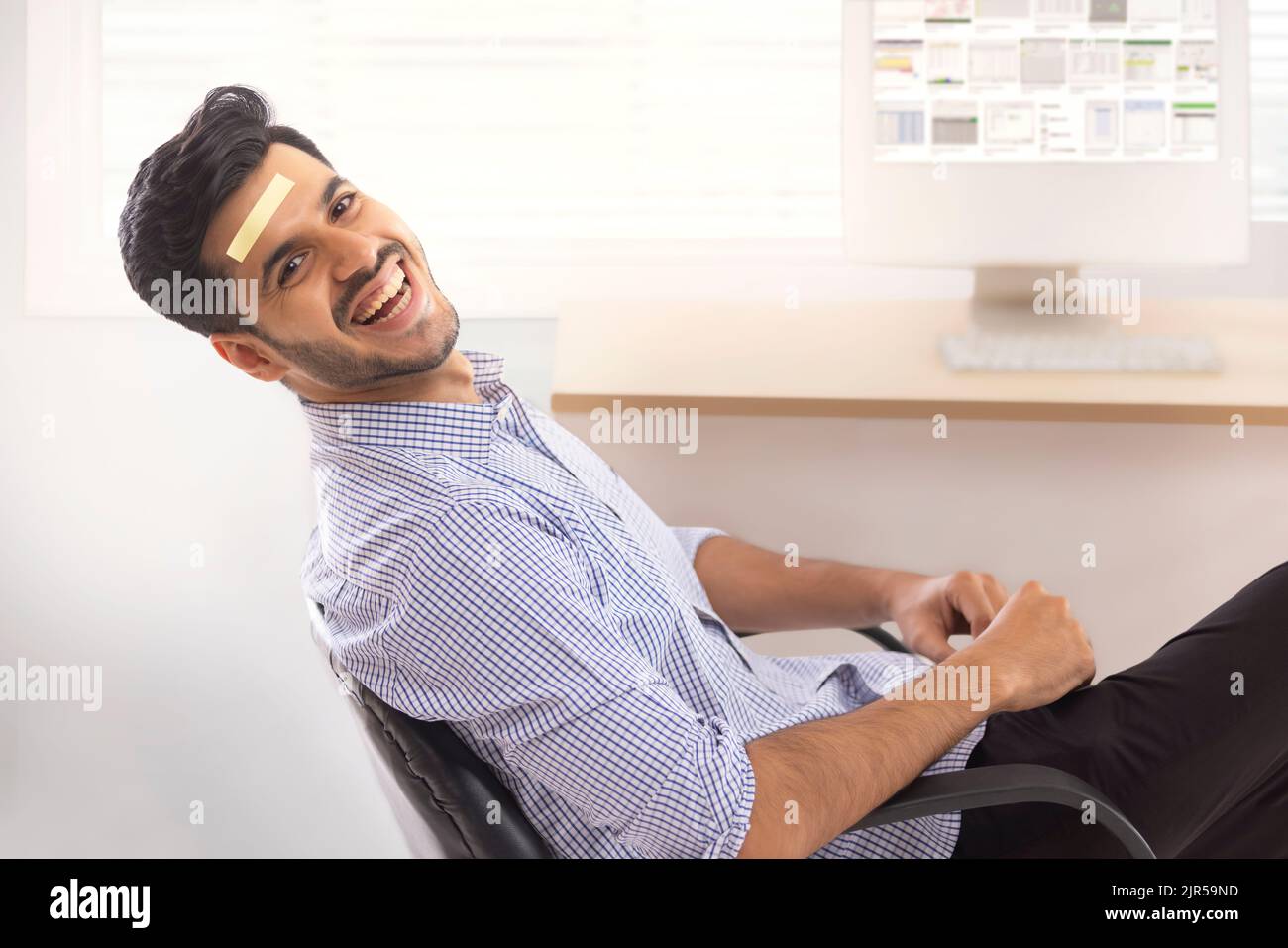 A corporate employee sitting in formal clothing smiling with blank ...