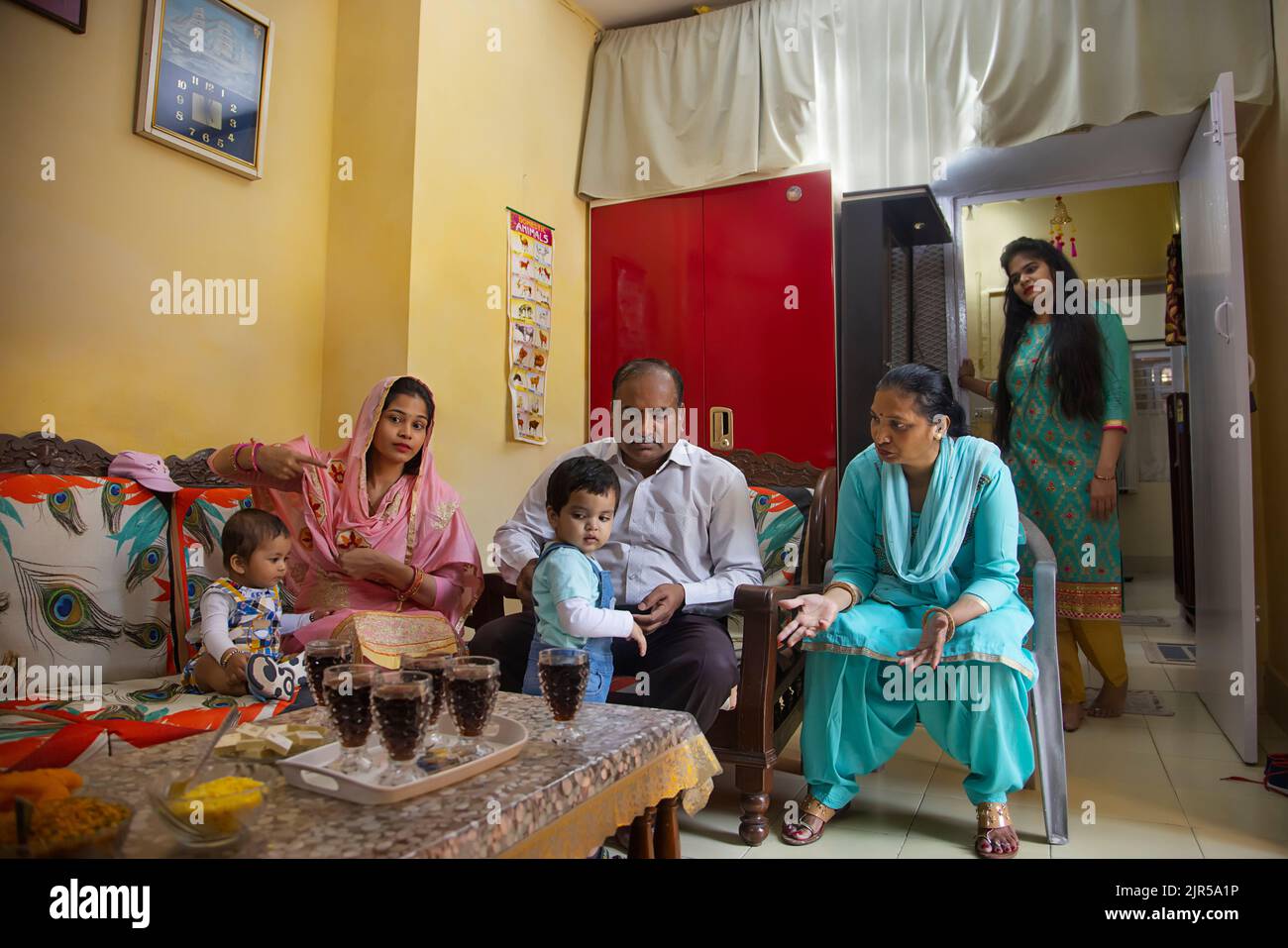 Indian Family members sitting in living room Stock Photo - Alamy
