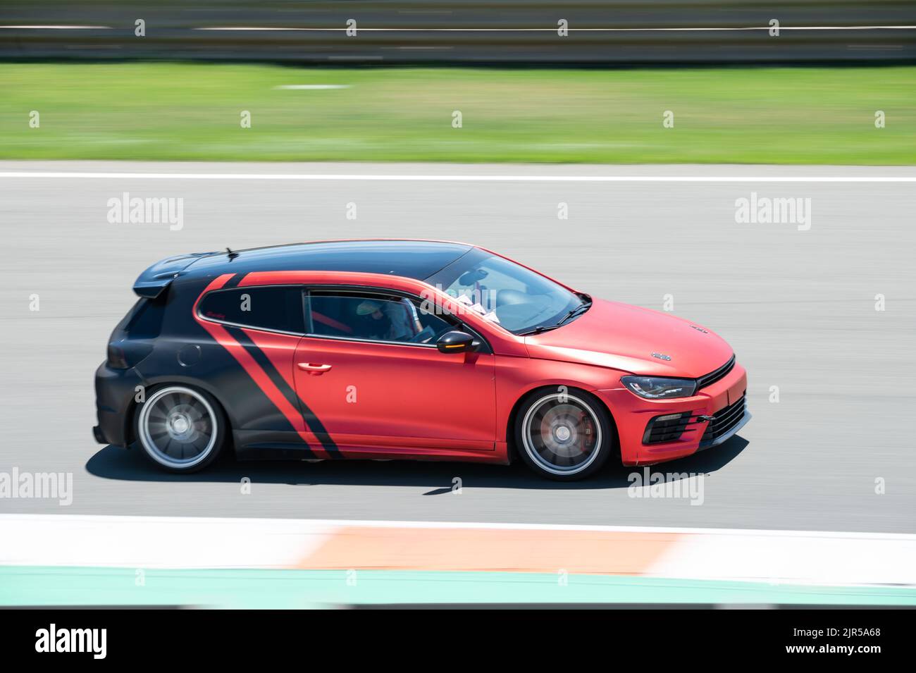 A red Volkswagen Scirocco racing on the racing circuit Stock Photo - Alamy