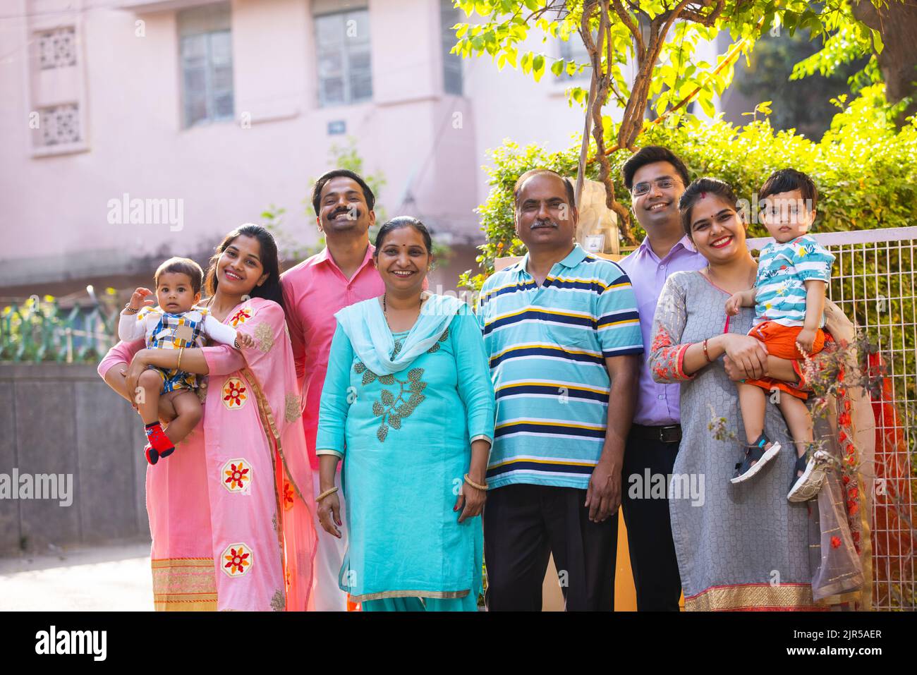Portrait of happy family members standing in front of gate Stock Photo ...