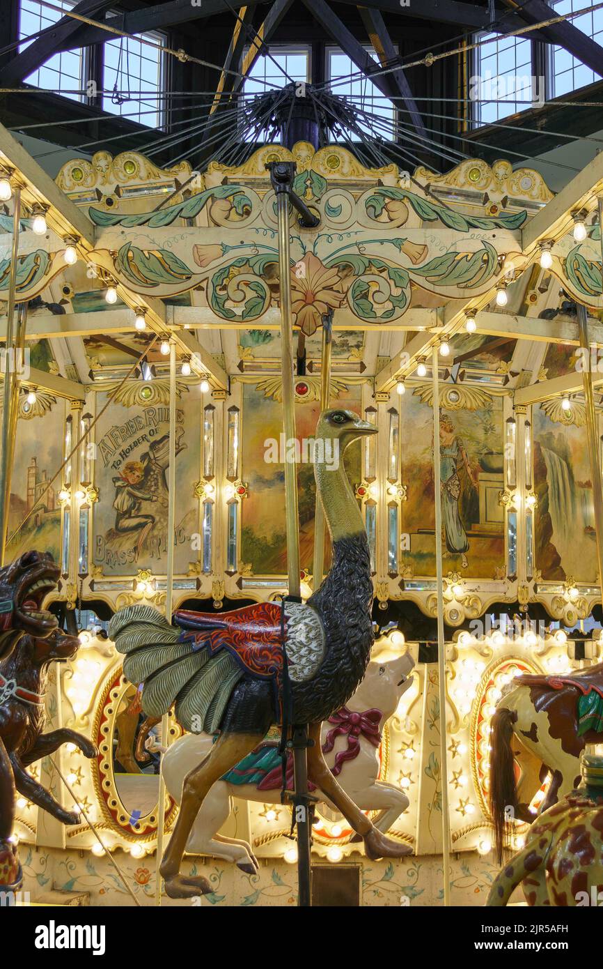 An antique carousel with an inticate ostrich carving below and ...