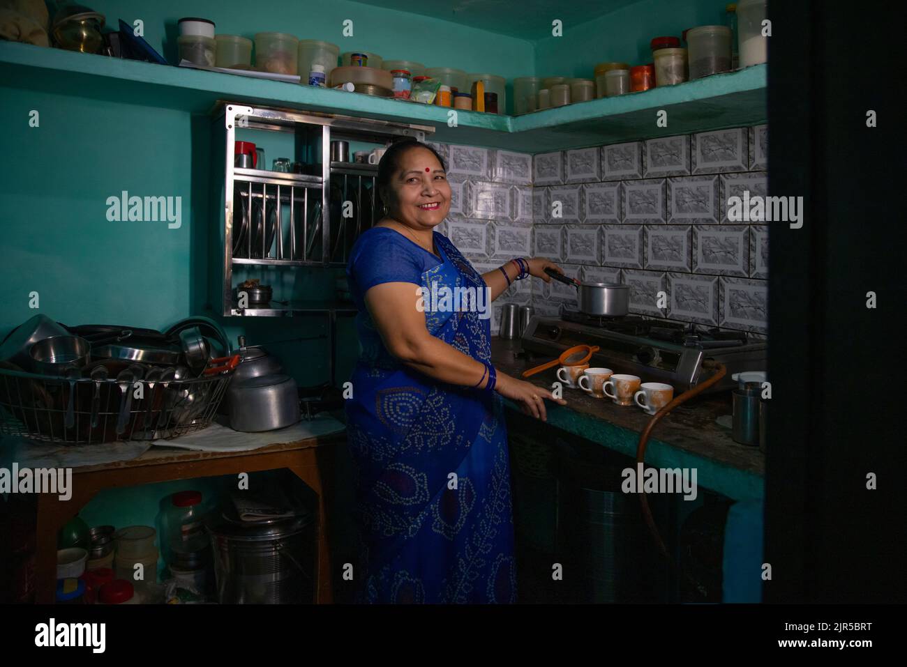 Indian woman making hot tea hi-res stock photography and images - Alamy