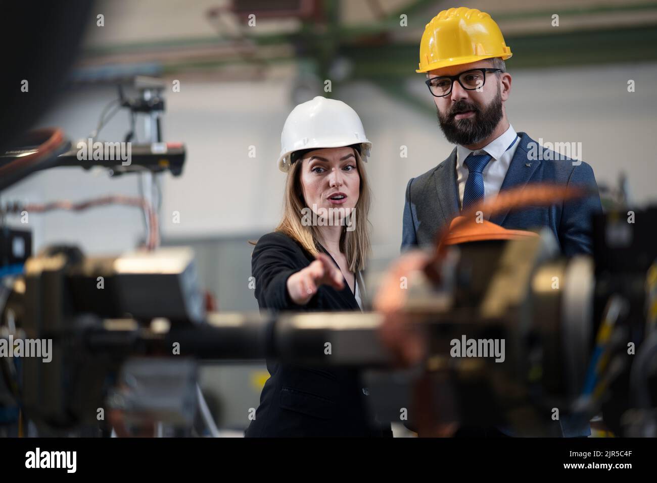 Chief engineer and project manager in modern industrial factory with ...