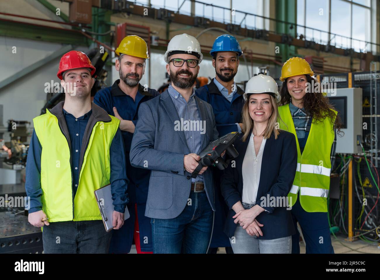 Young man worker with Down syndrome with manager and other collegues ...