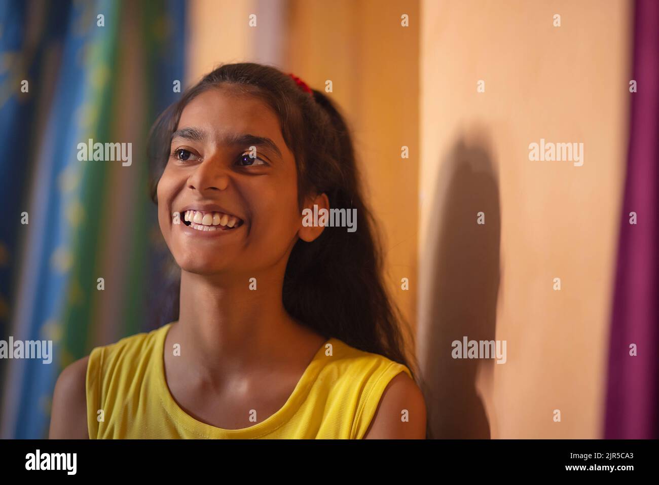 Portrait of a teenage girl looking elsewhere and smiling Stock Photo ...