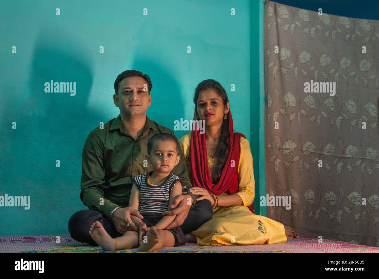 Portrait of happy parent with their child looking at camera while ...