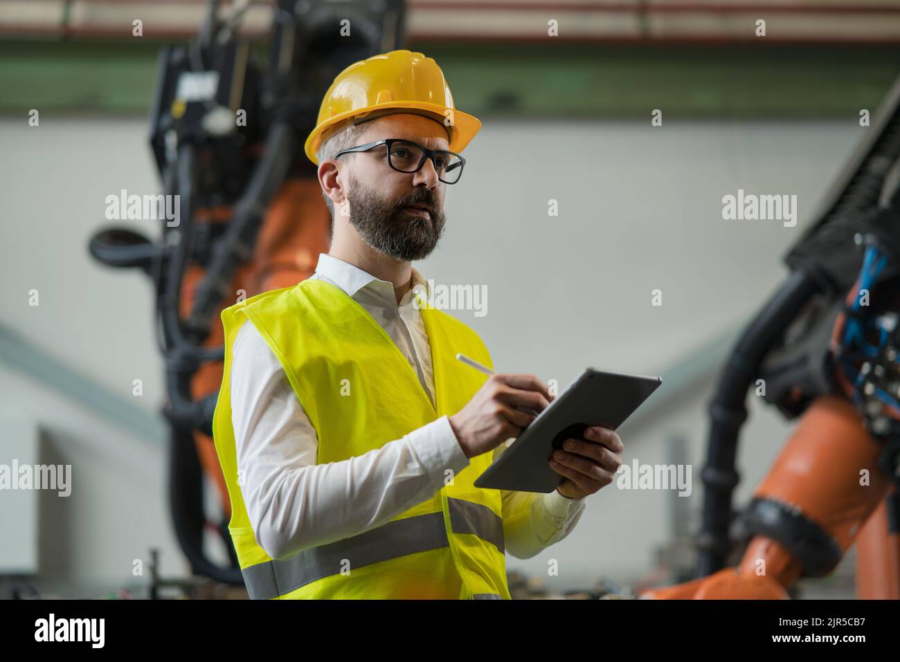 Automation engineer holding digital tablet in industrial in factory ...
