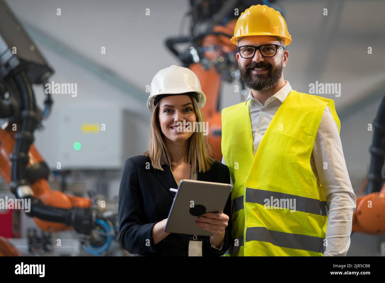 Chief engineer and project manager in modern industrial factory with ...