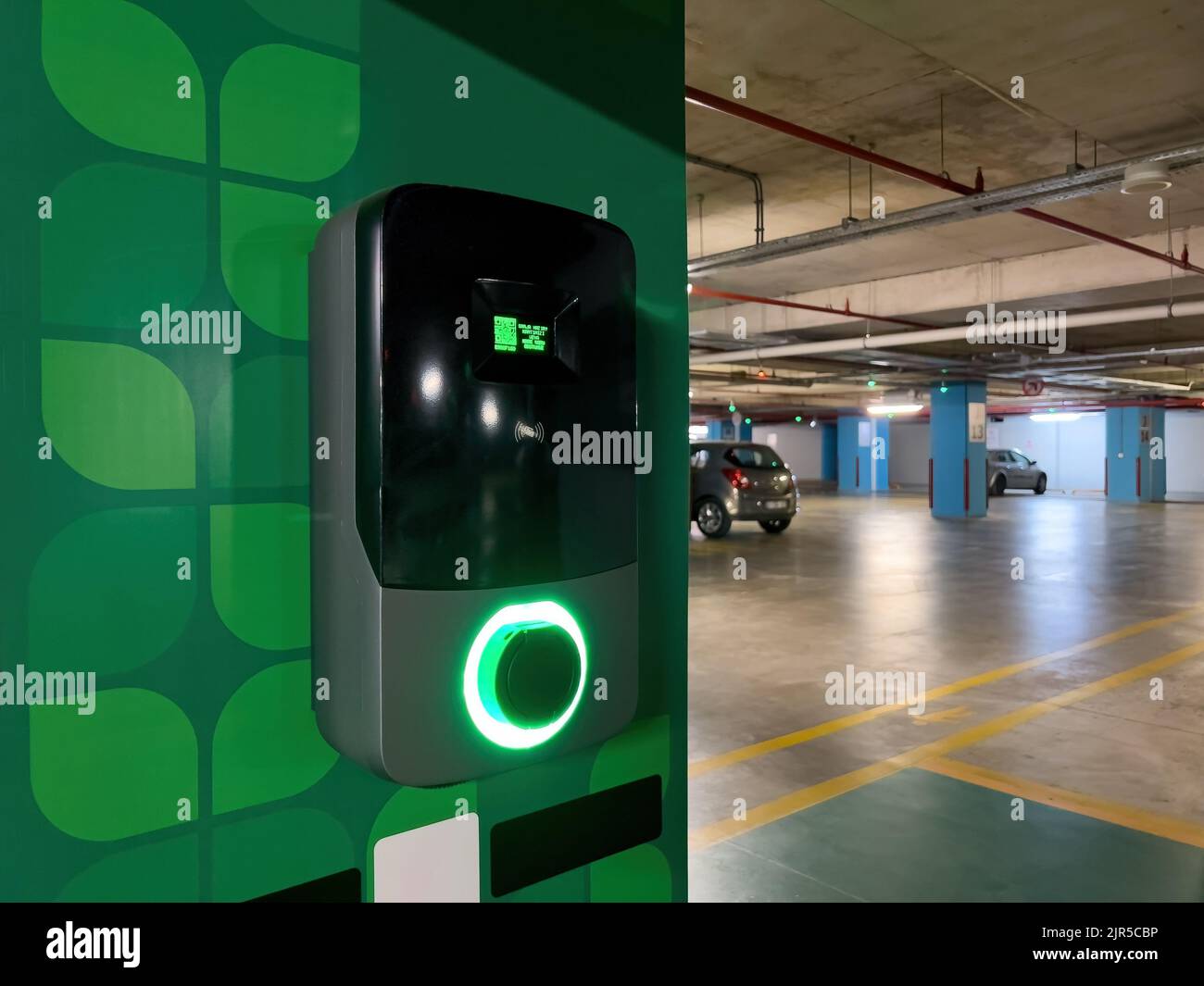 Electric car charging station in the indoor parking lot of the shopping ...
