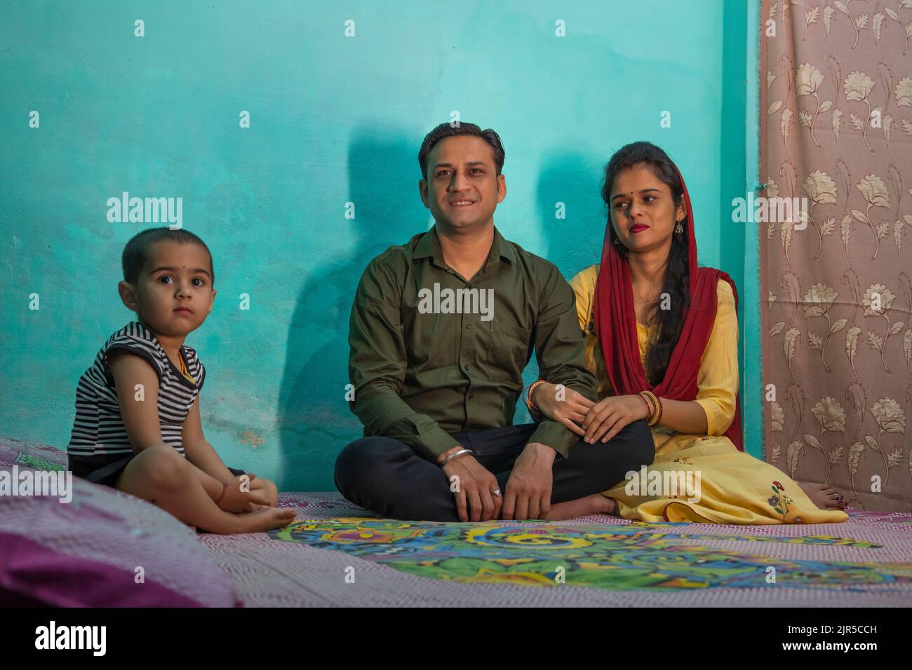 Portrait of happy parent with their child looking at camera while ...