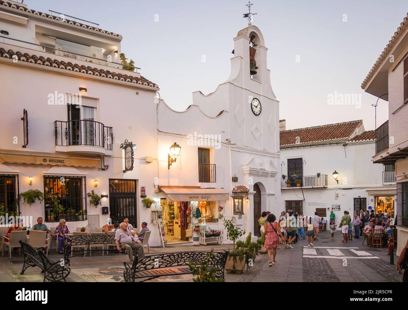 Busy summer with tourists in Spanish white village in the evening ...