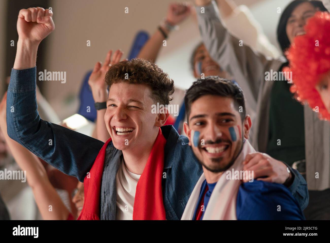 Excited football fans supproting French national team in live soccer ...