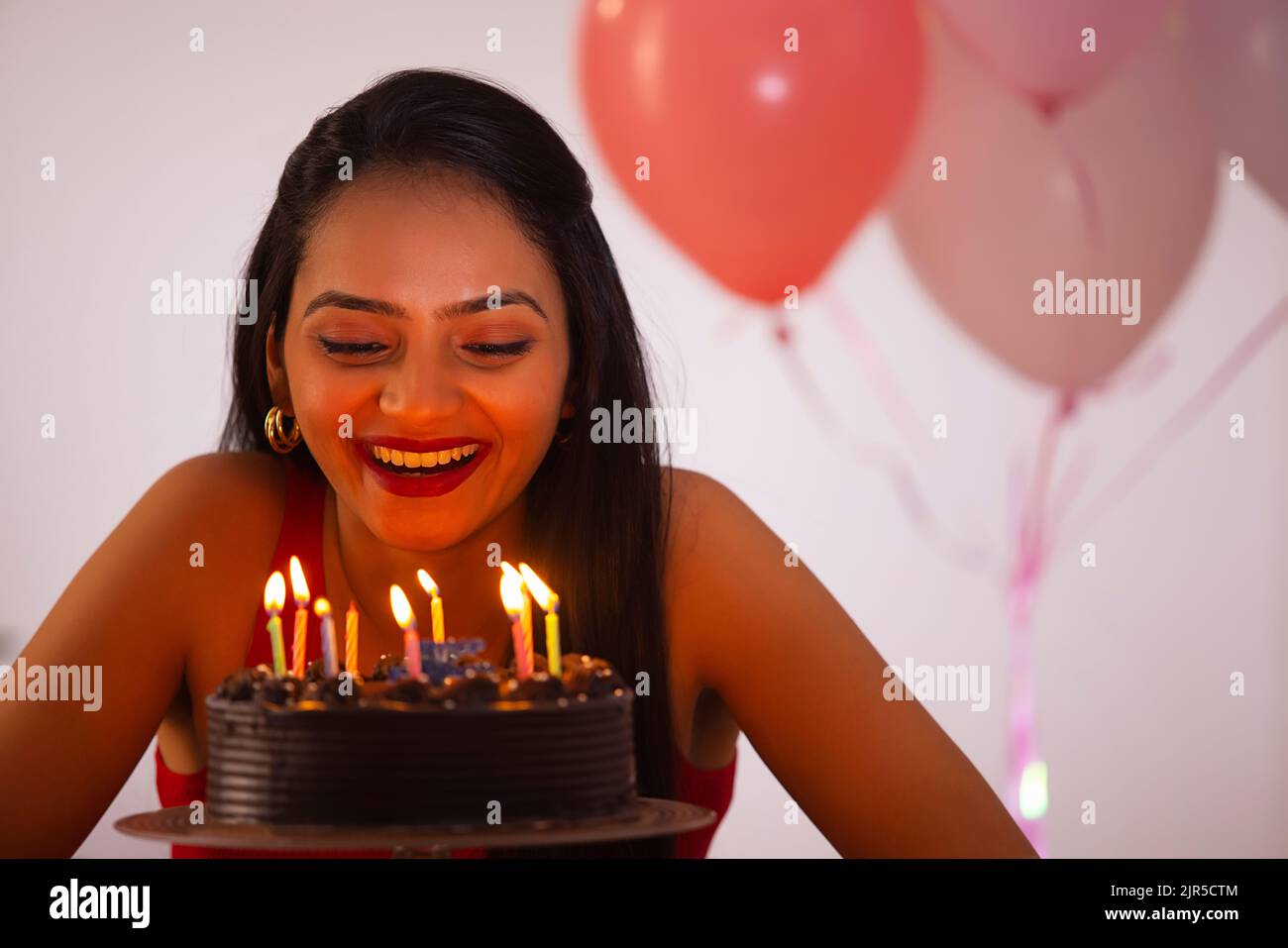 Beautiful young woman celebrating her birthday at home Stock Photo - Alamy