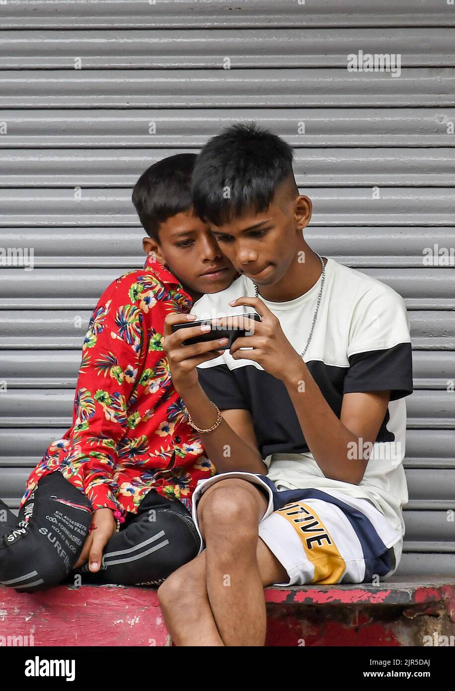 A boy is engrossed on his smartphone in Mumbai. With 5G service soon to ...