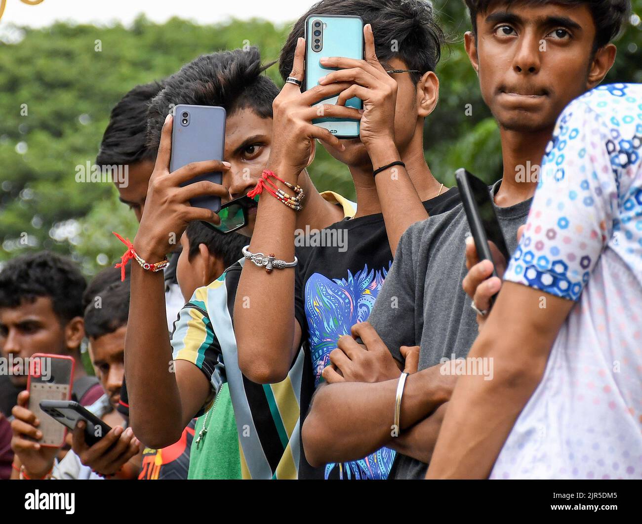 Youngsters take photos and record videos with their smartphone in ...