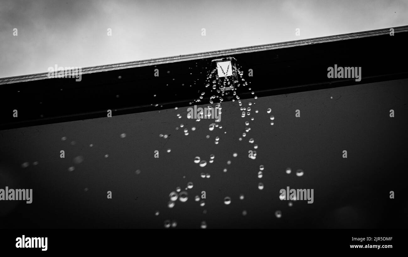 A low angle shot of failing water droplets in grayscale Stock Photo - Alamy