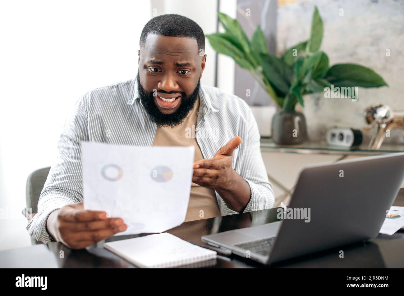 Confused puzzled african american business man, freelancer or company ...