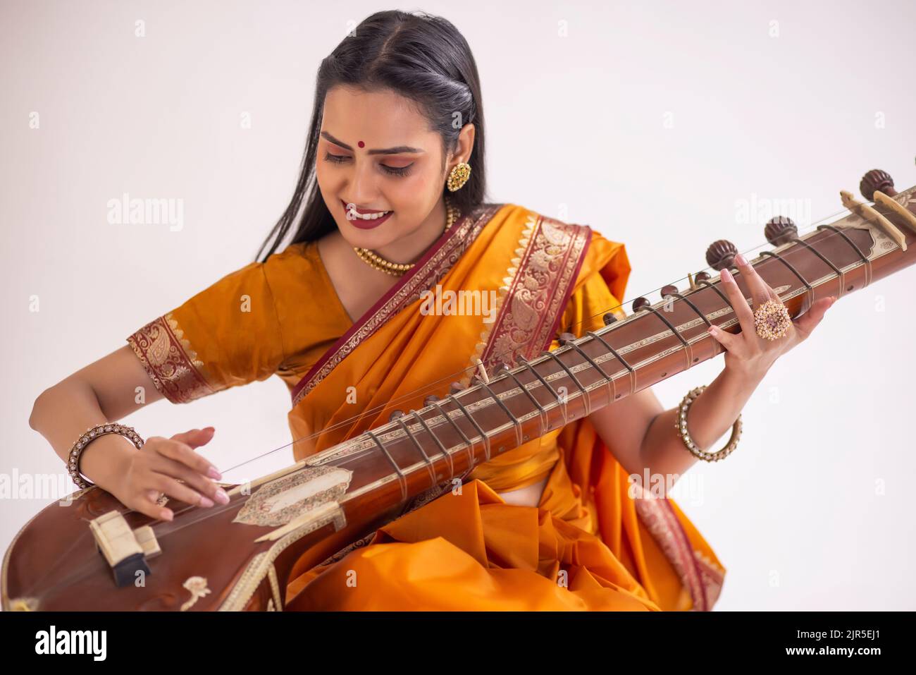Young woman playing sitar hi-res stock photography and images - Alamy