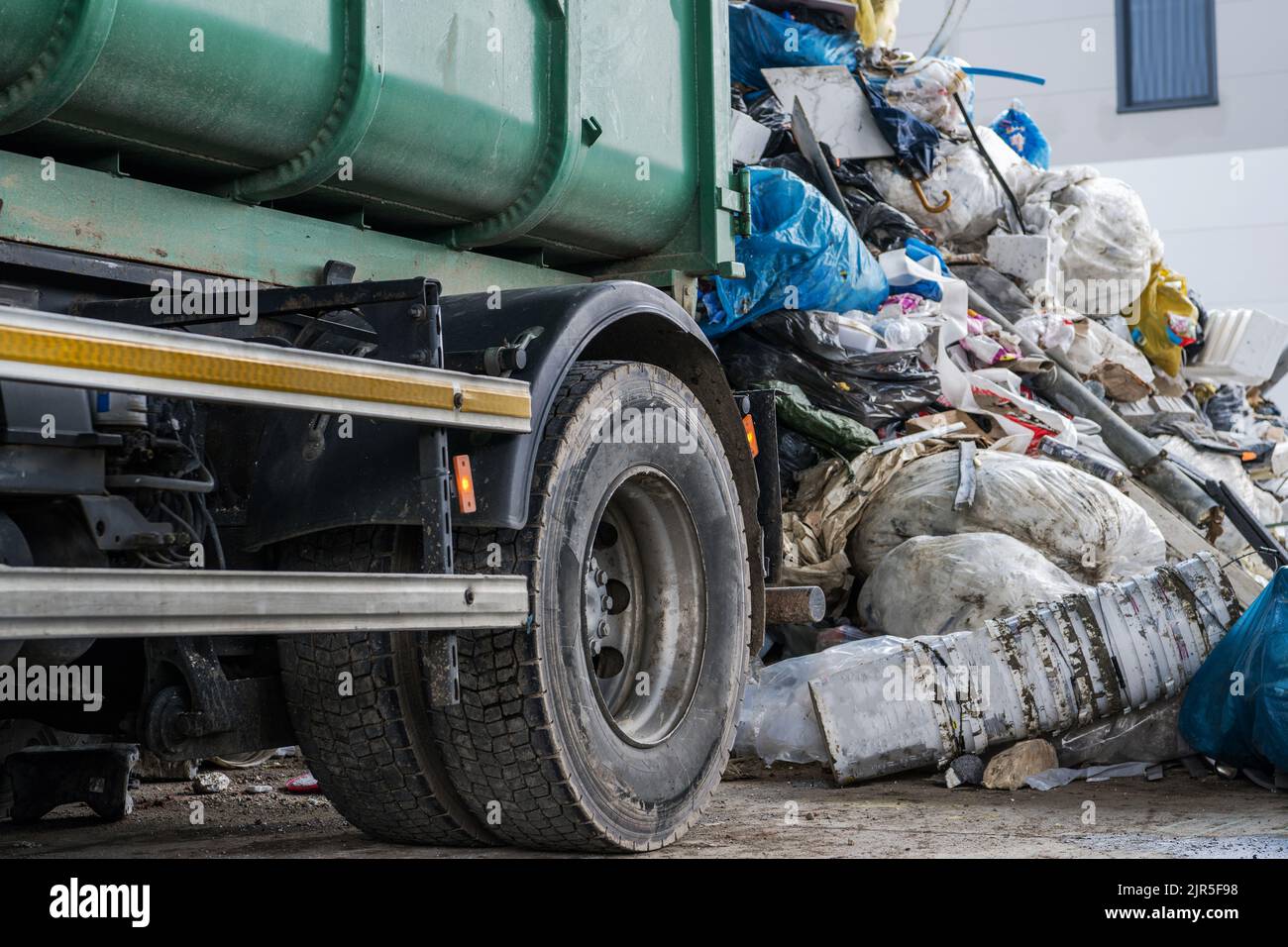 Modern Garbage Truck Close Up and the Pile of Trash. Waste Management ...