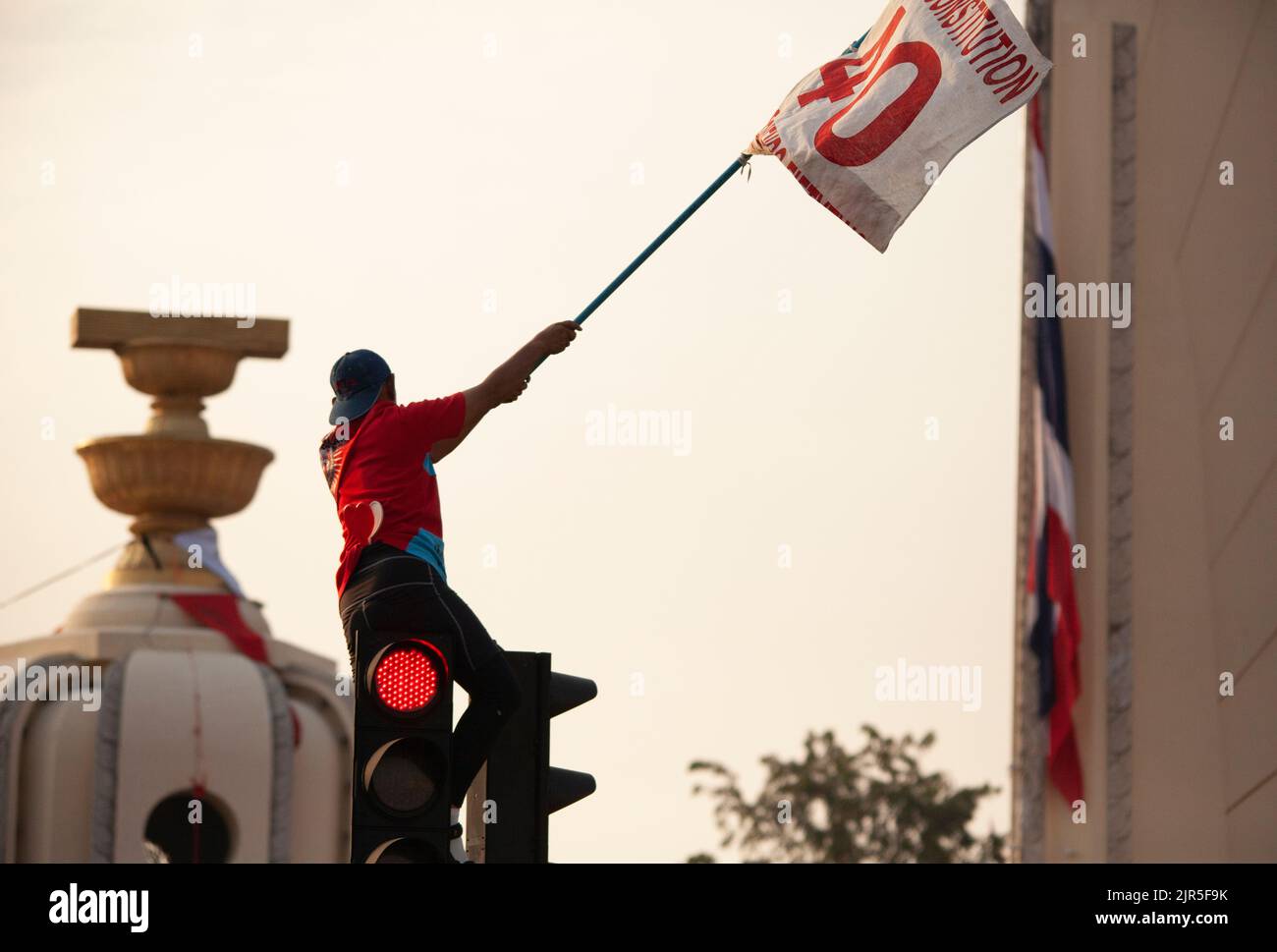 Bangkok, Thailand - December 10, 2010: Red Shirt protestant waves flag ...