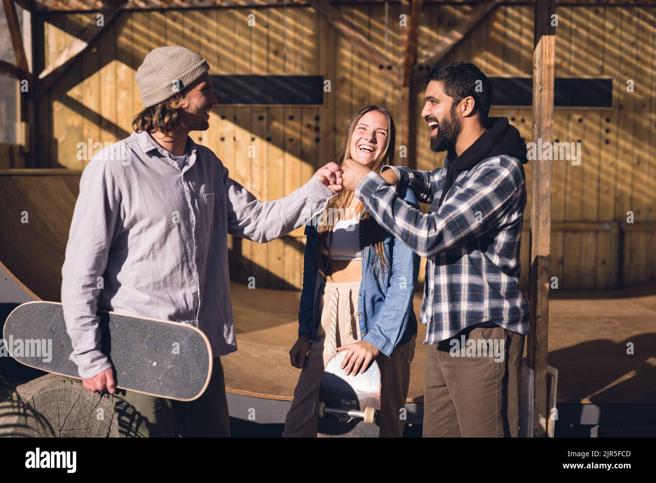 Image of happy diverse female and male friends with skateboards in ...
