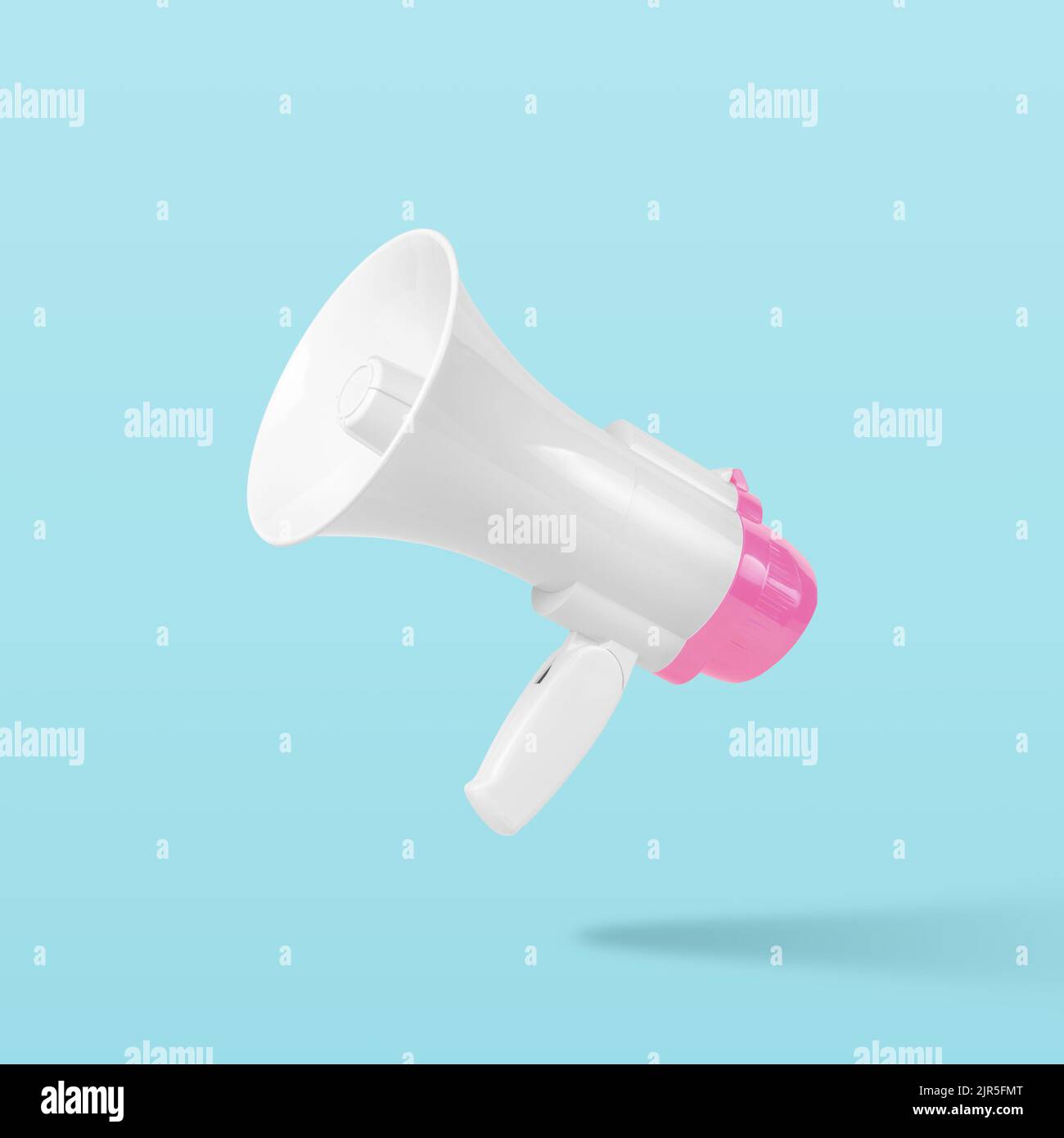 White-pink megaphone on pastel blue background. Minimal advertising ...